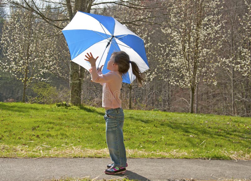 Small Girl Playing with Umbrella on Windy Day. Stock Photo - Image of ...