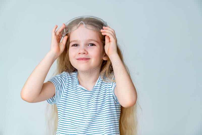 Small Girl Put on Safety Goggles. Stock Photo - Image of childhood ...