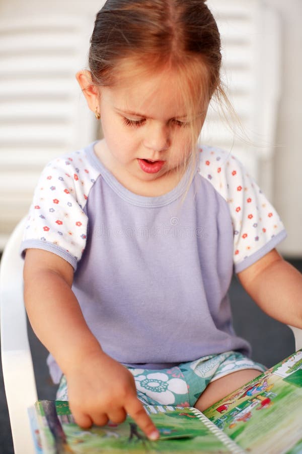 Small girl reading stock photo. Image of storytime, funny - 2865000