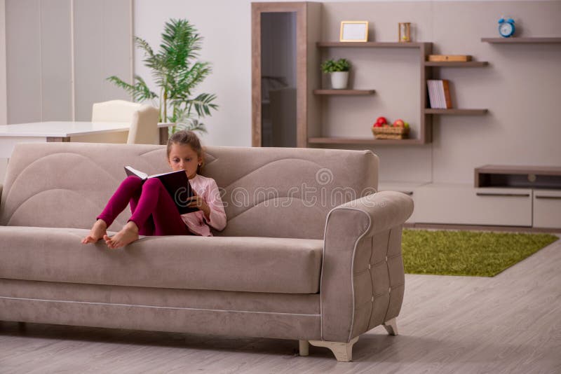 Small Girl Reading Book at Home Stock Photo - Image of home, exam ...