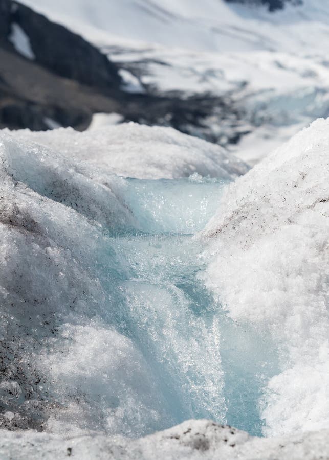 Glacial Melt Causes a Waterfall Over Harsh Cliffs Stock Image - Image ...
