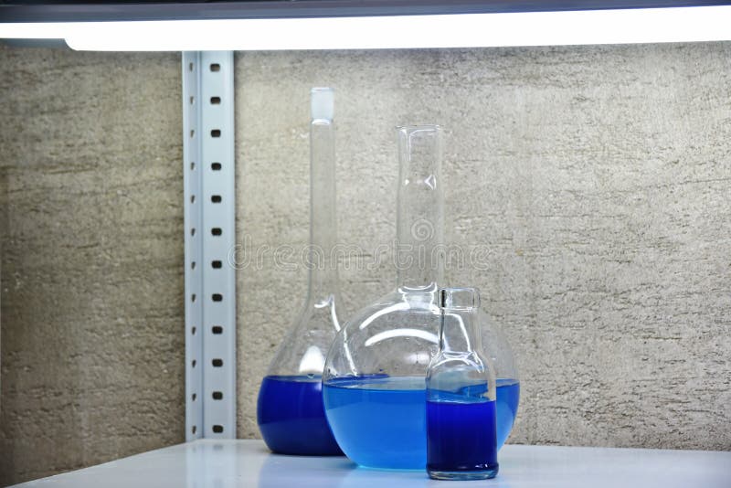 Small Glass Container with Liquid on the Background of Other Flasks ...