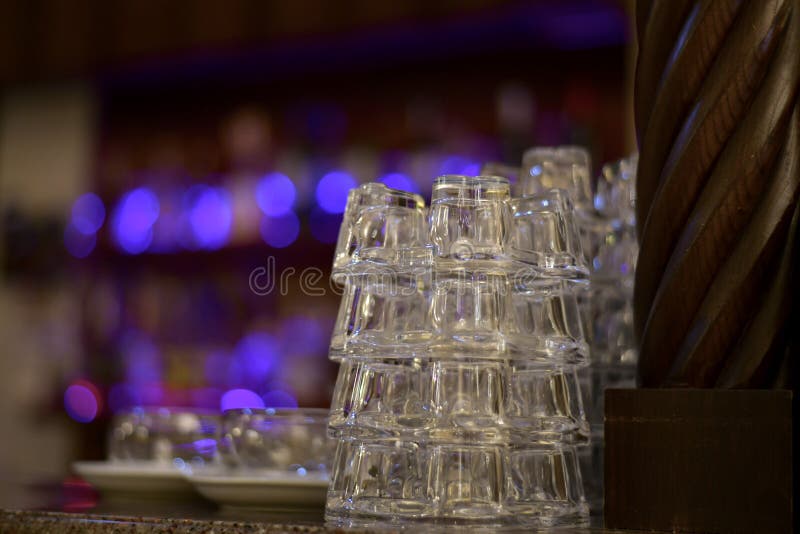Small Glass Cups with Neat Stack Vertical Rows on the Bar. Amid the ...
