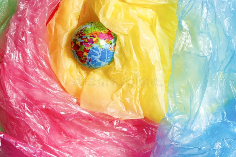 Small Globe between a Heap of Plastic Bags. Plastic Excessive Use ...