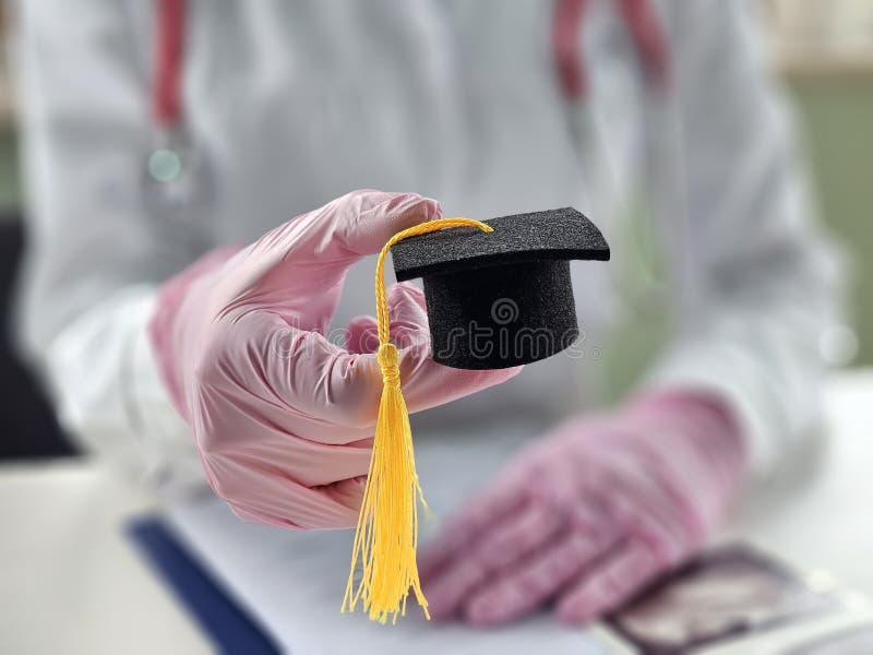 Small Graduation Cap Held by a Person Wearing Gloves in an Academic ...