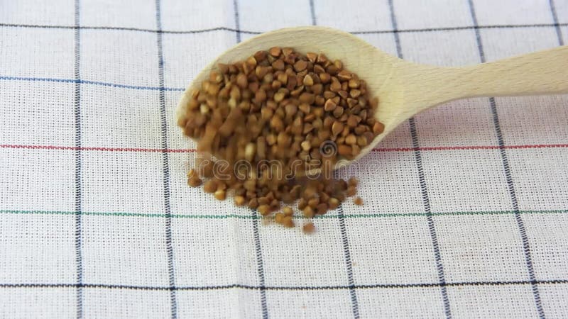 Small Grains of Natural Buckwheat are Superimposed with a Wooden Spoon ...