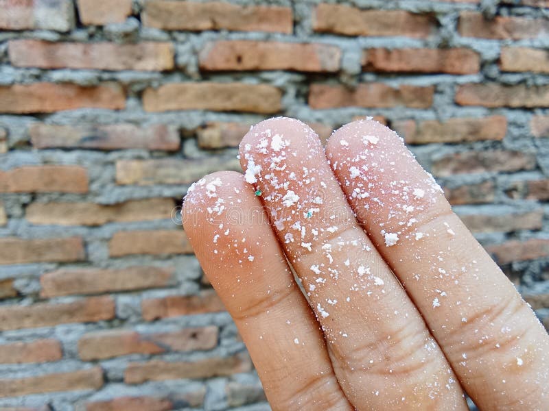 Small Granules of Microplastic Stuck between the Fingers Stock Photo ...