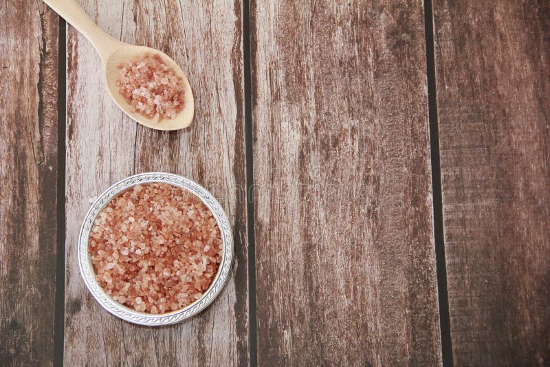 Small Granules of Natural Himalayan Salt in a Wooden Spoon and a ...