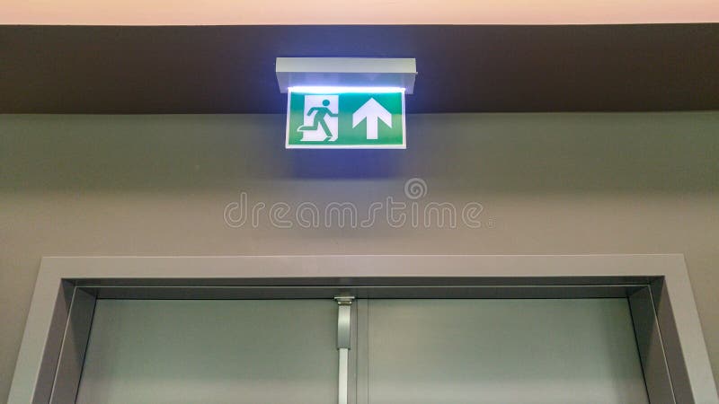 Small Green Emergency Exit Sign in Office Stock Image - Image of ...