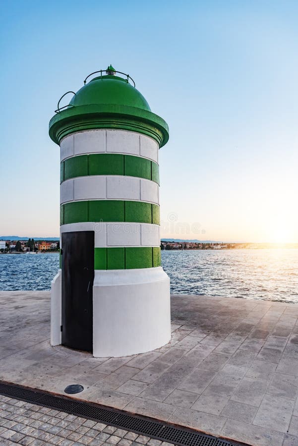A Small Green Lighthouse on the Waterfront. Stock Image - Image of ...