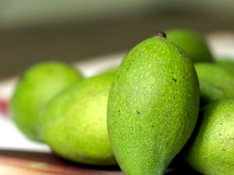 Small Green Mangoes on a Wooden Table Stock Image - Image of closeup ...