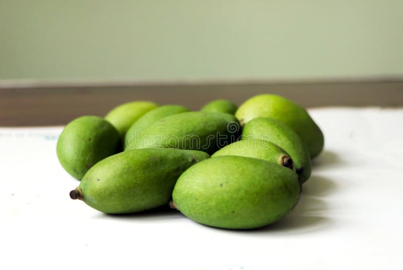 Small Green Mangoes on a Wooden Table Stock Image - Image of vegetable ...