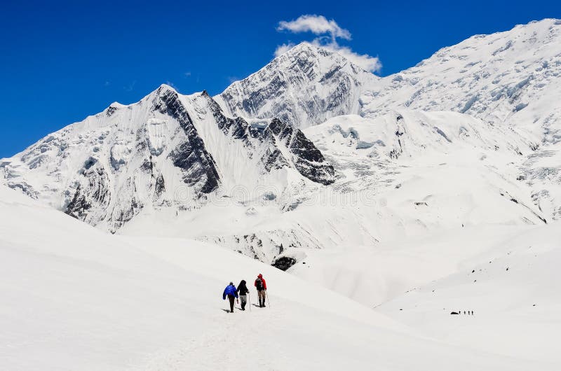 Small Group of Mountain Trekkers in High Winter Himalayas Mountains ...