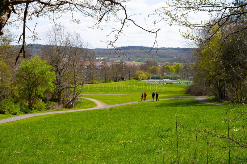Small Group of People Wandering on a Path through a Green Park.. Stock ...