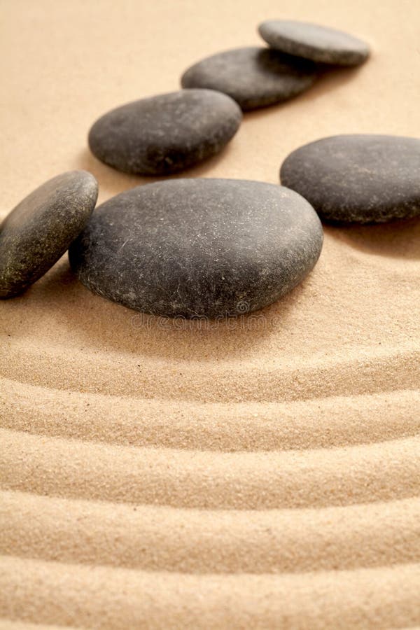 Small Group of Smooth Black Stones in Sand Stock Photo - Image of ...