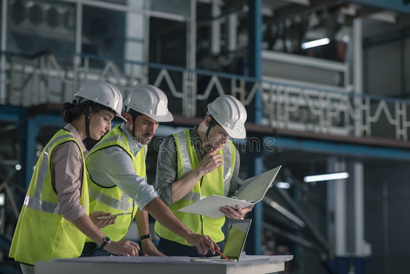 Small Group of Technical Engineers Working in the Factory Stock Photo ...