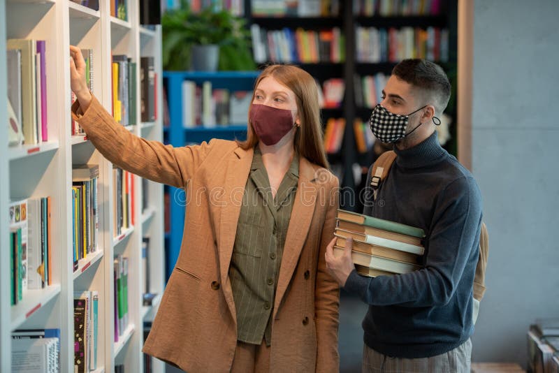 Small Group of Young Students in Masks Choosing Books Stock Image ...