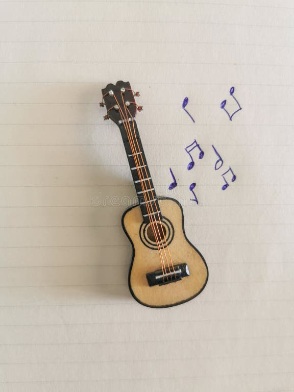 Small Guitar with Music Notes Drawing on Notebook Stock Photo - Image ...