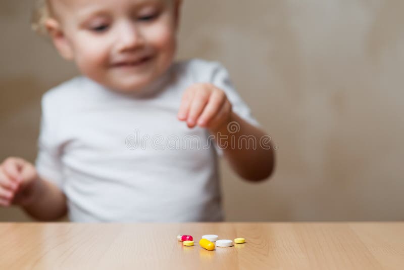 A Small Handful of Pills on the Table and a Blurred Baby in the ...