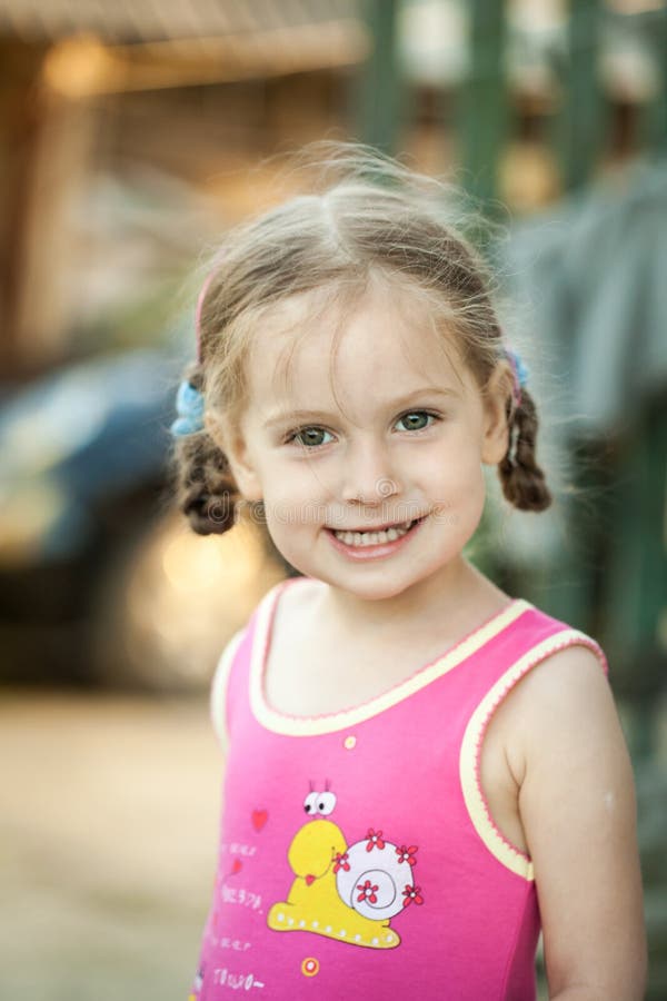 Small happy girl on a farm stock image. Image of girl - 107805157