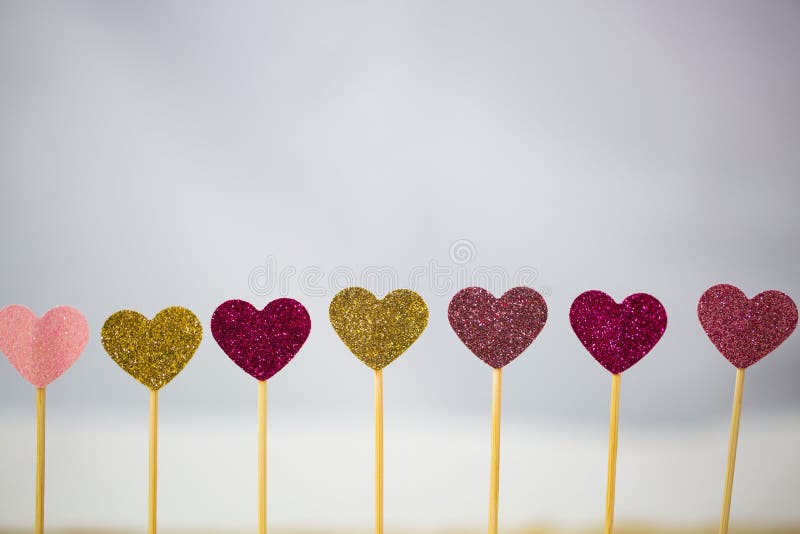 Small Hearts in a Row, Lights in the Background Stock Photo - Image of ...