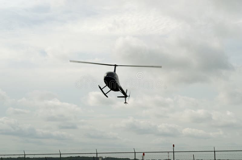 Small Helicopter Flying Low Stock Image - Image of clouds, flying ...