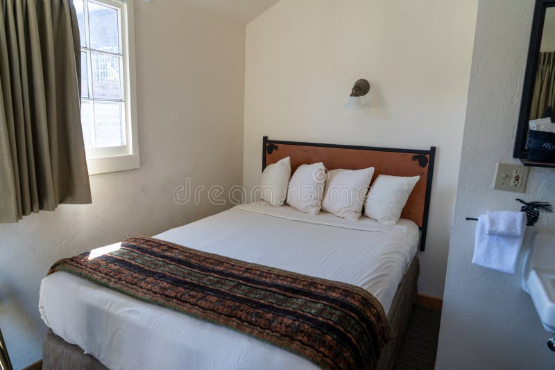 Small Hotel Room with One Double Bed, and Minimal Decor Stock Photo ...