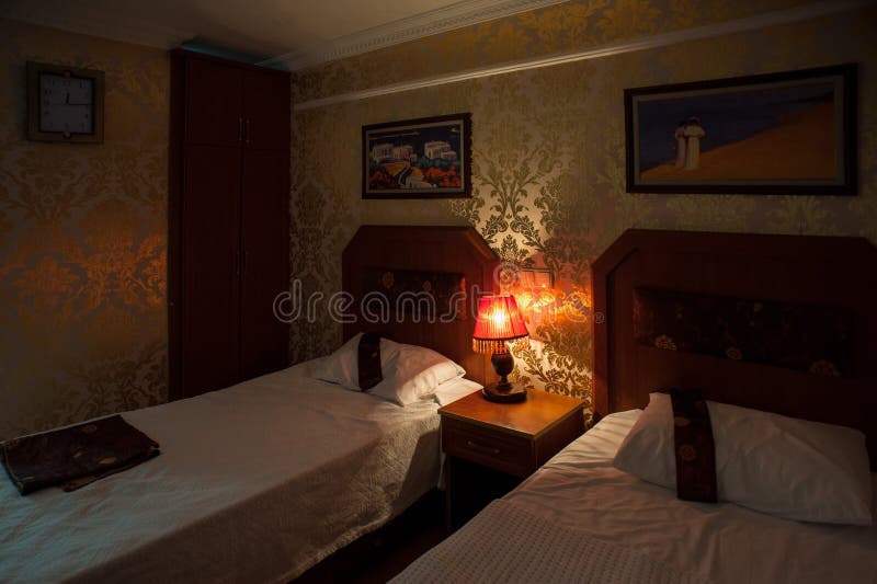 A Small Hotel Room with Two Beds and a Lamp on the Table Stock Image ...