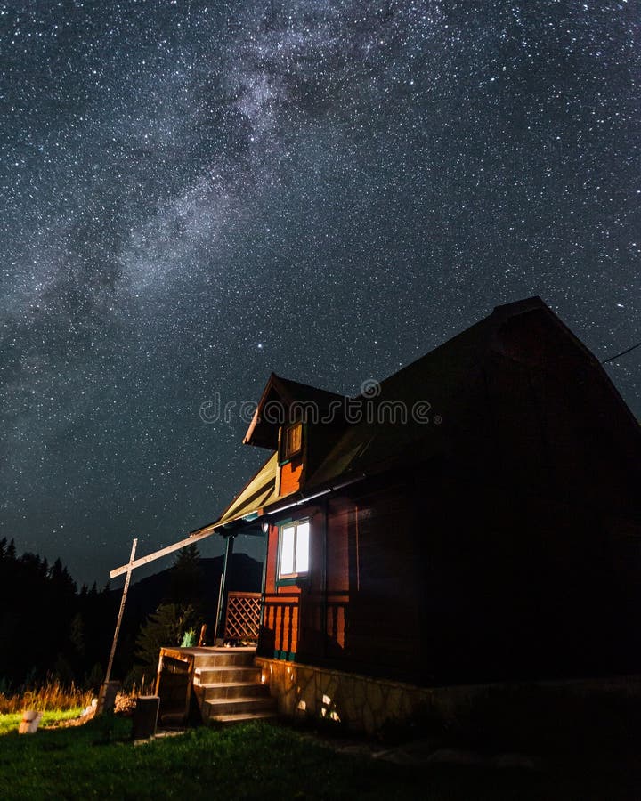 Small House in a Forest Under a Glowing Starry Sky at Night Stock Image ...