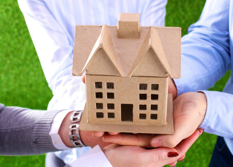 A Small House in the Hands. Big Plans for the Future Stock Photo ...