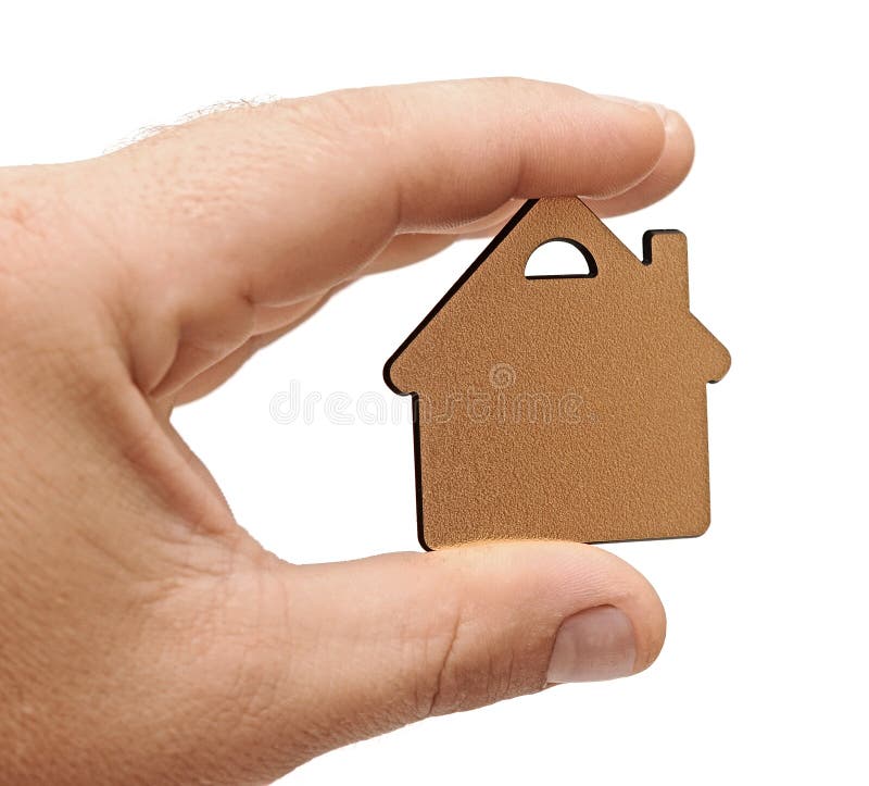 Small house in human hand stock photo. Image of ownership - 26519432