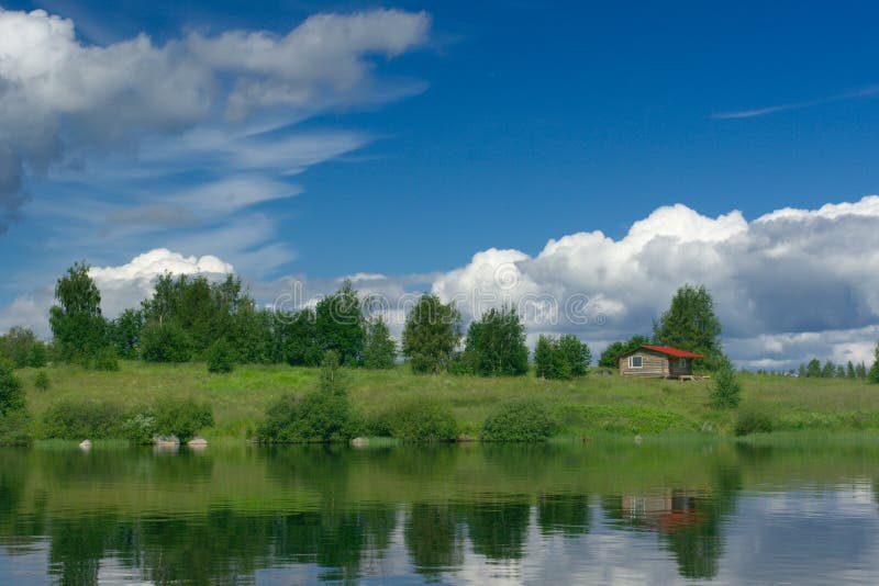 Small house on lake shore stock image. Image of cottage - 4904591
