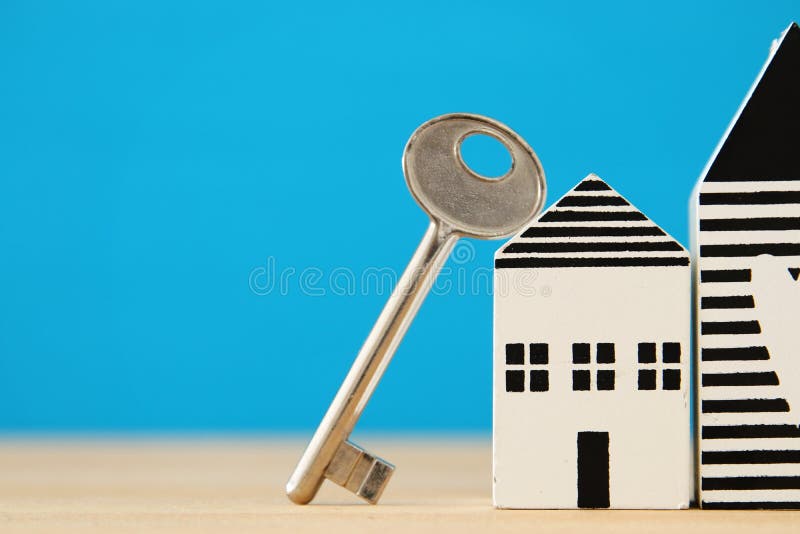 Small House Model with Key Over Wooden Floor. Selective Focus Stock ...