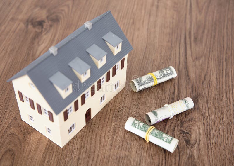 Small House Model and Scattered Dollar Bills on the Table Stock Image ...