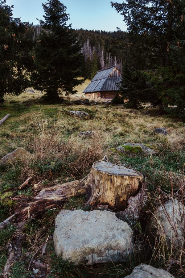 A Small House Sits in a Field Surrounded by Large Rocks Stock Photo ...
