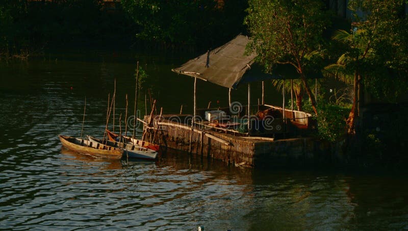 A Small Hut by the River and a Boat at Rest Stock Image - Image of arab ...