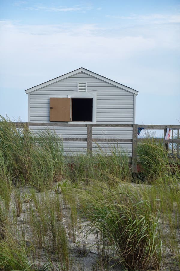Small Hut on a Sandy Beach Surrounded by Tall Grass with it`s Window ...