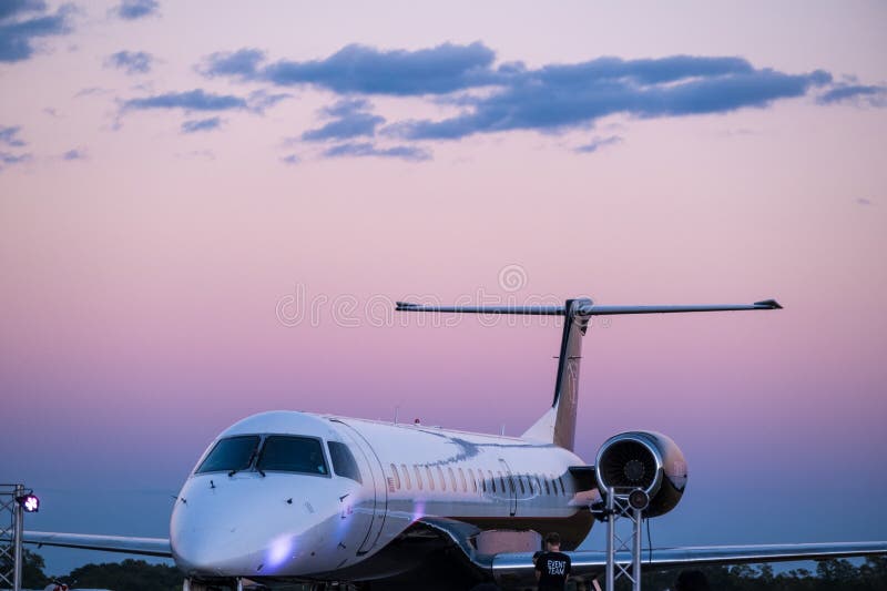 Small Jet Airplane on Runway at Sunset Stock Photo - Image of beautiful ...