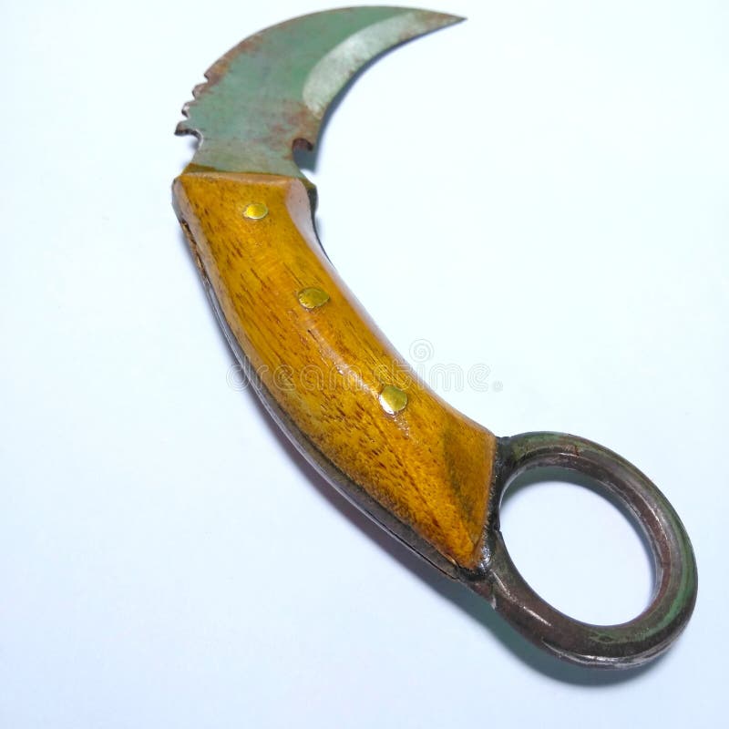 Small Kerambit with a Wooden Handle Stock Photo - Image of orange ...