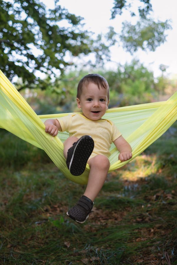 Small Kid on Yellow Hammock in Spring Forest Stock Photo - Image of ...