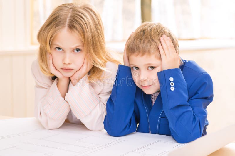 Small Kids are Leaning on Table and Frowning Stock Photo - Image of ...