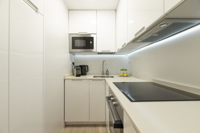 Small Kitchen with Plain White Cabinets, Matching Stone Countertops and ...