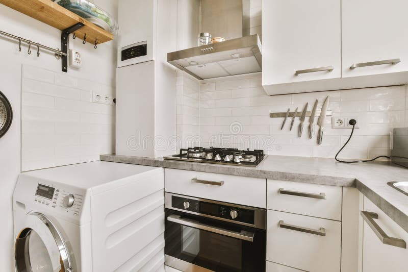 A White Kitchen with White Cabinets and a Washing Machine Stock Photo ...