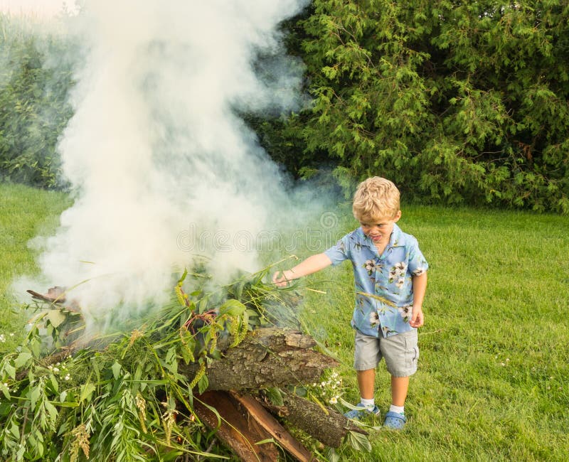 A Young Boy Building a Bonfire Stock Photo - Image of backyard, bonfire ...