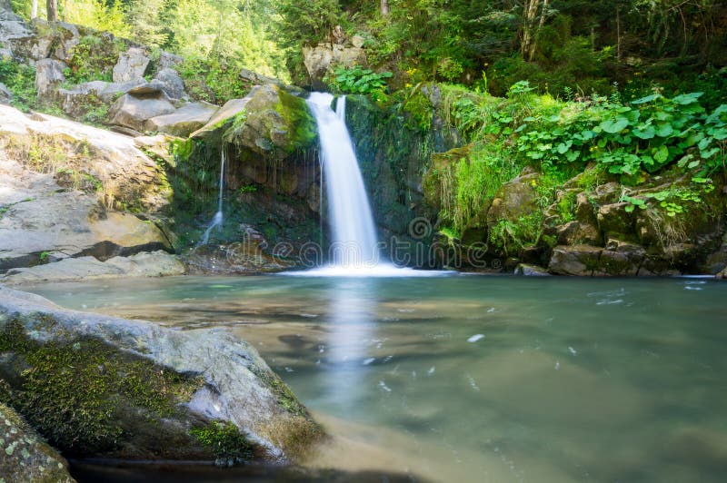 A Small Lake with a Waterfall in the Mountains Stock Photo - Image of ...