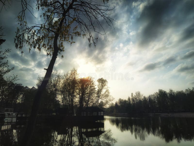 Sunset Over a Forest Lake, Clouds Reflecting in the Water. Stock Photo ...