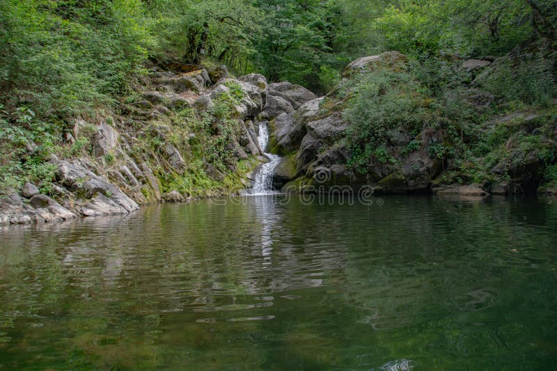 Small Lake and Waterfall. Beautiful Waterfall in the Forest Stock Photo ...