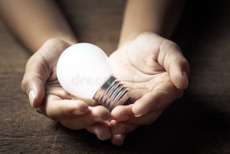 Small Light Bulb in Hands stock image. Image of creative - 162967257