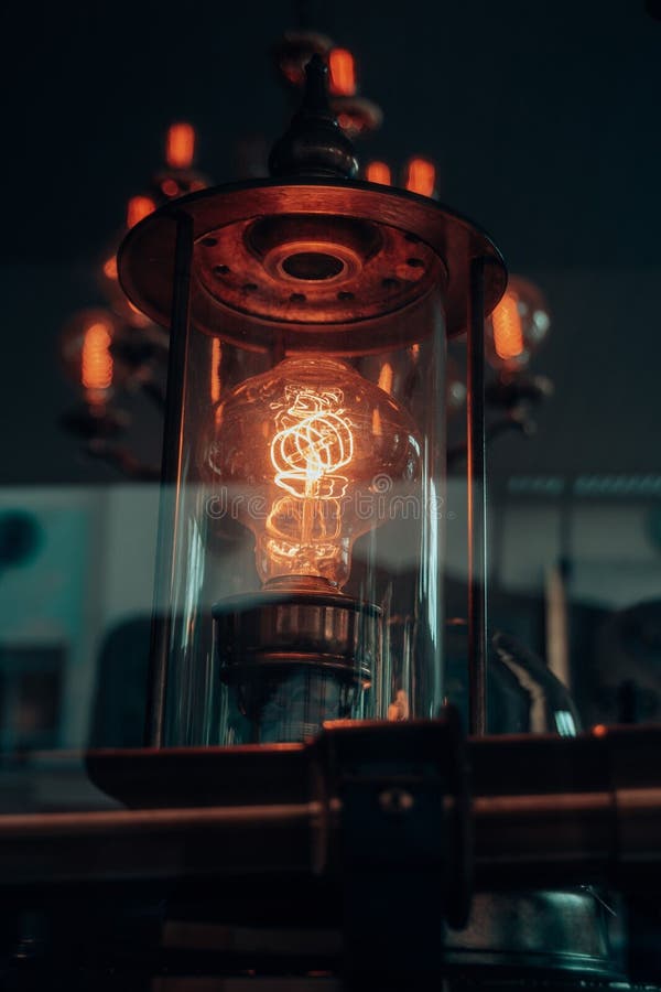 A Small Light Bulb Lit from the Top in a Dark Room Stock Photo - Image ...