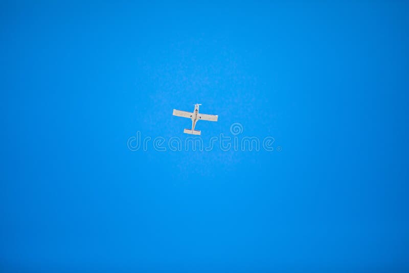 A Small Light Plane Flies in the Clear Sky. View from Below. Horizontal ...